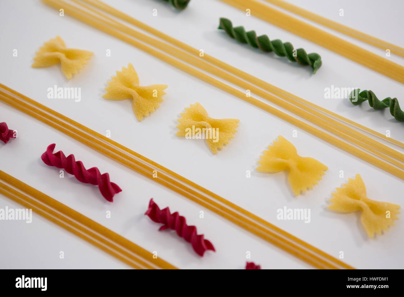 Various multicolored pasta arranged on white background Stock Photo - Alamy
