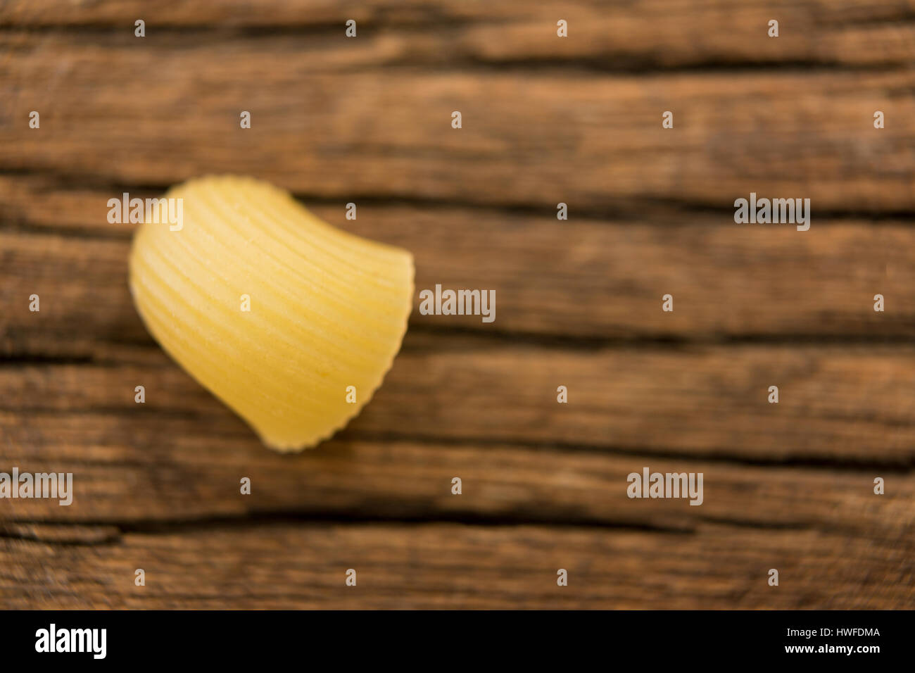 Lumache rigate pasta isolated on wooden surface Stock Photo - Alamy