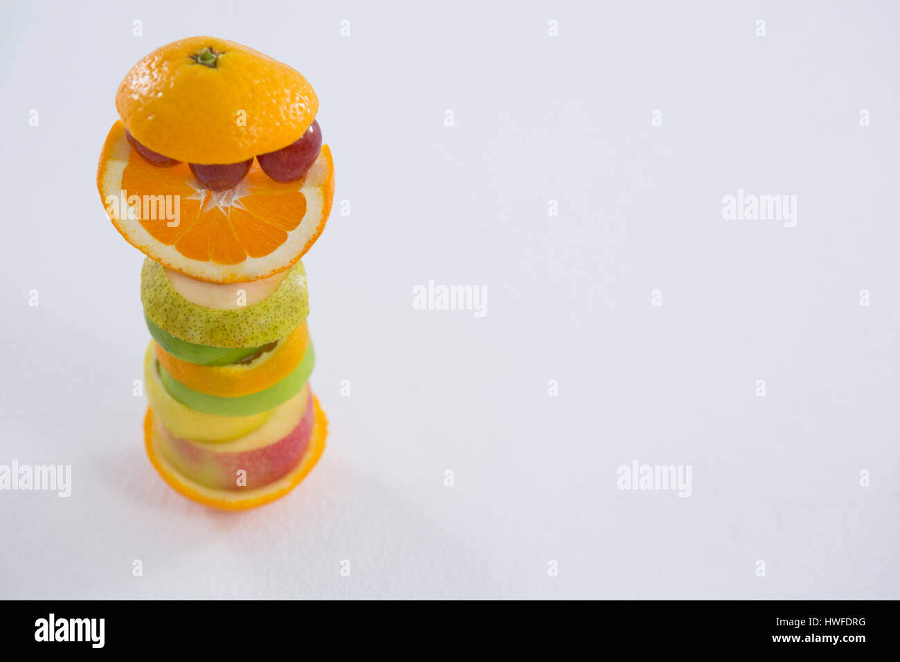 Stack of various fruits slices against white background Stock Photo - Alamy