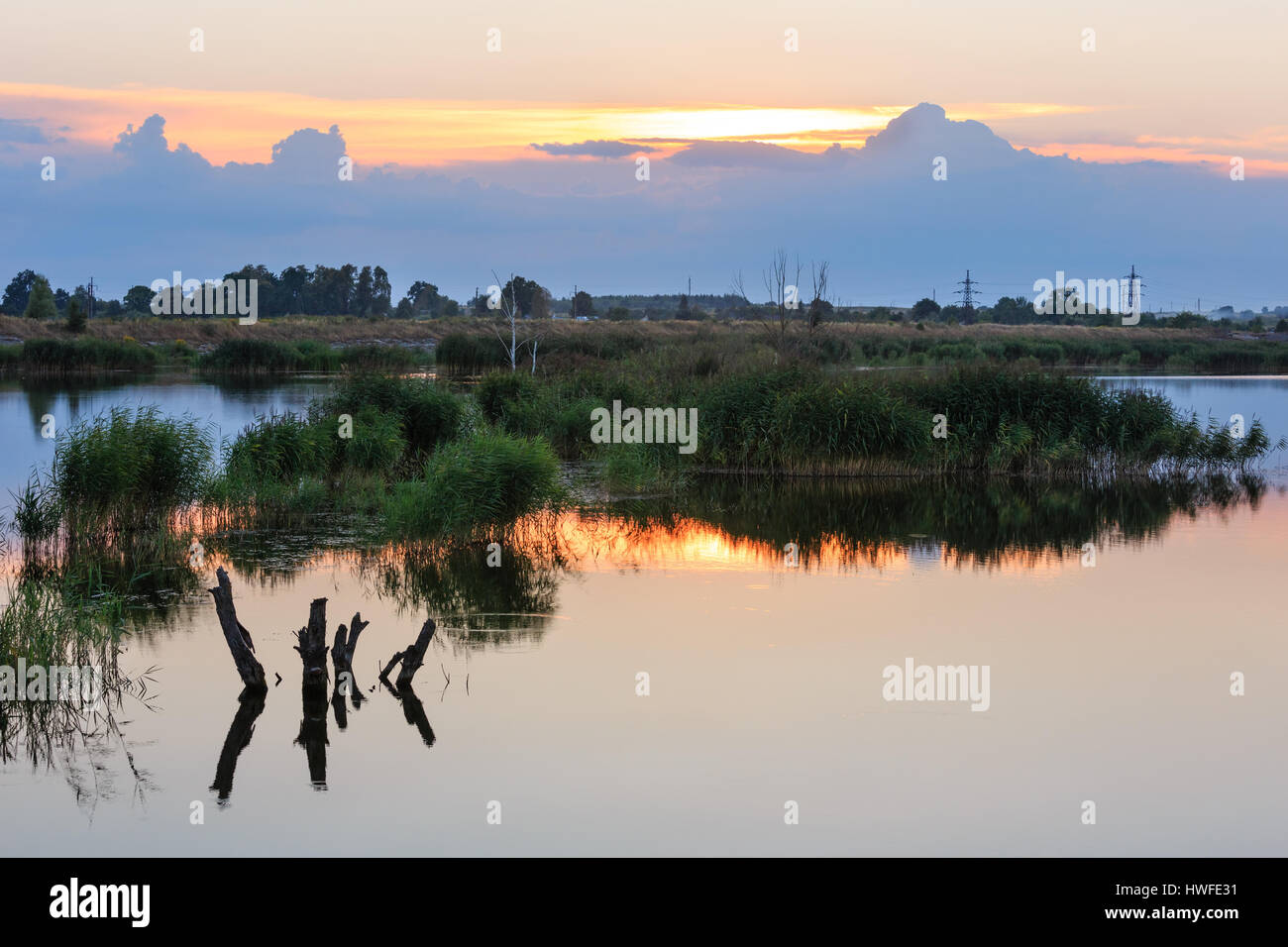 Sunset summer lake landscape with sun reflection on water surface (near ...