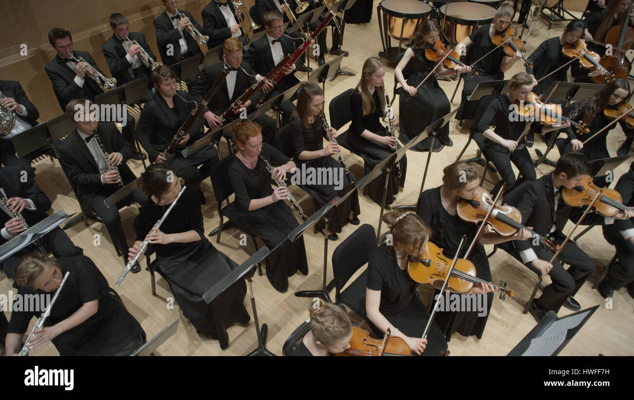 High angle view of student musicians playing instruments in orchestra ...