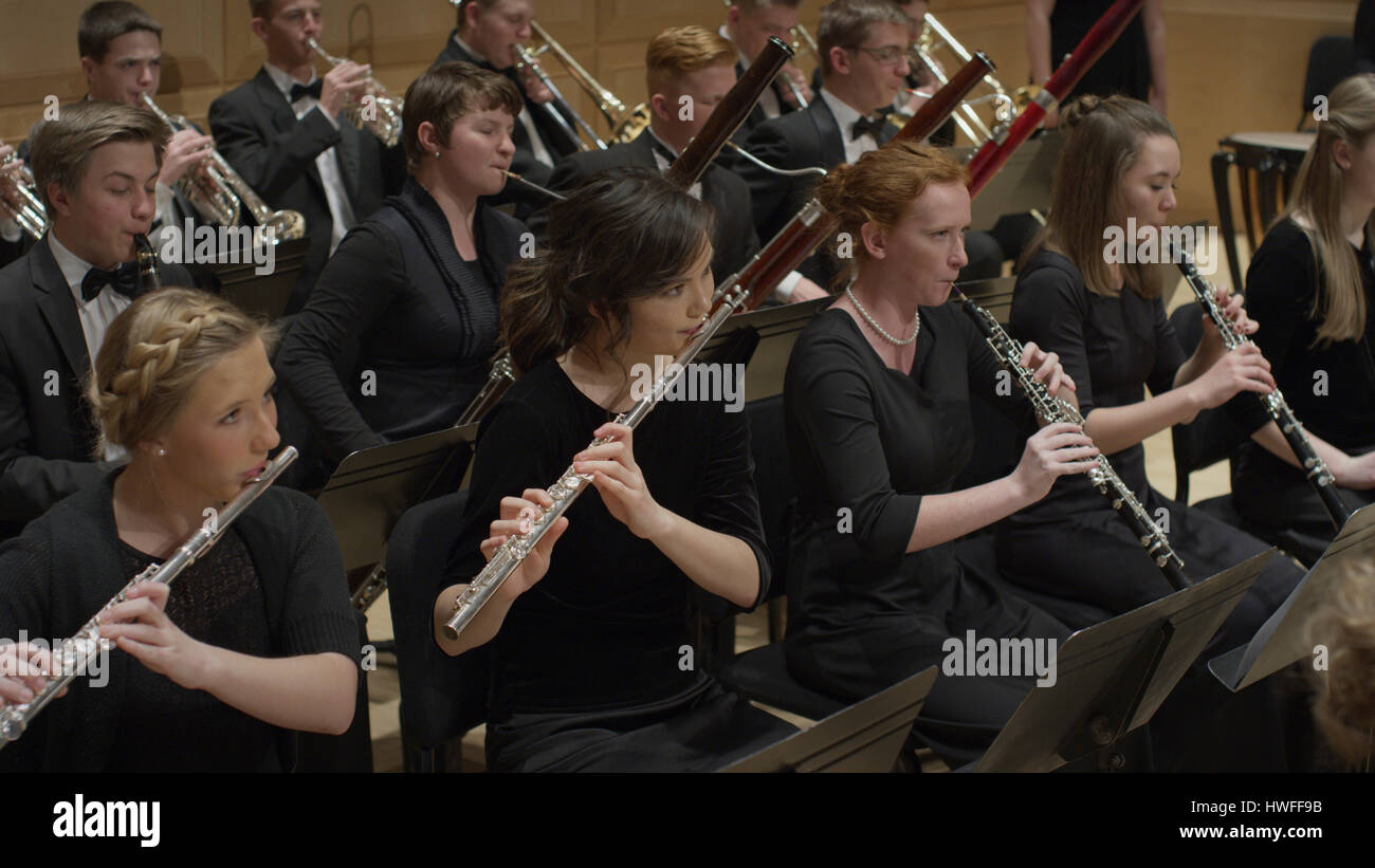 High angle view of student musicians playing flutes in orchestra ...