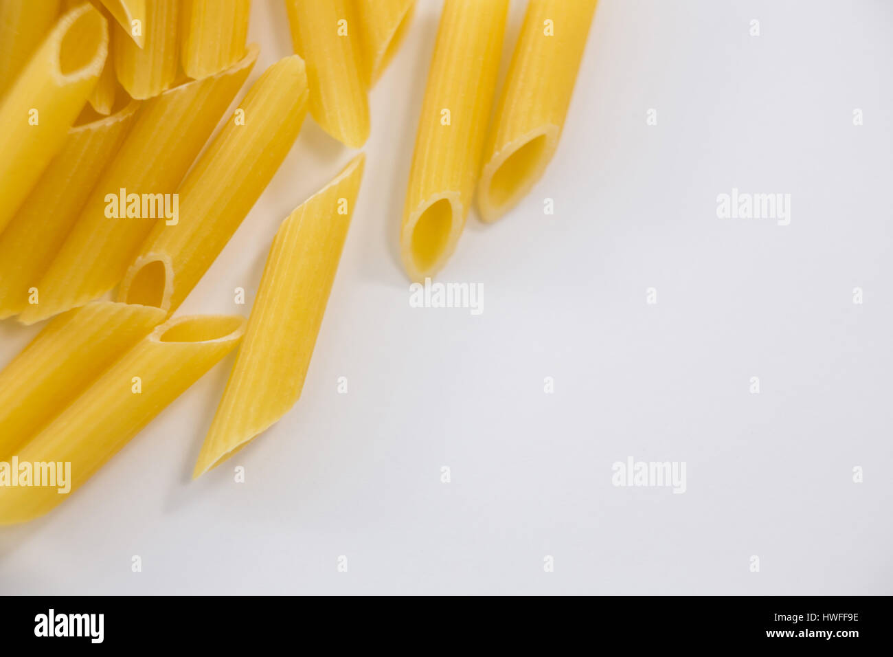 Yellow pennette isolated on white background Stock Photo - Alamy
