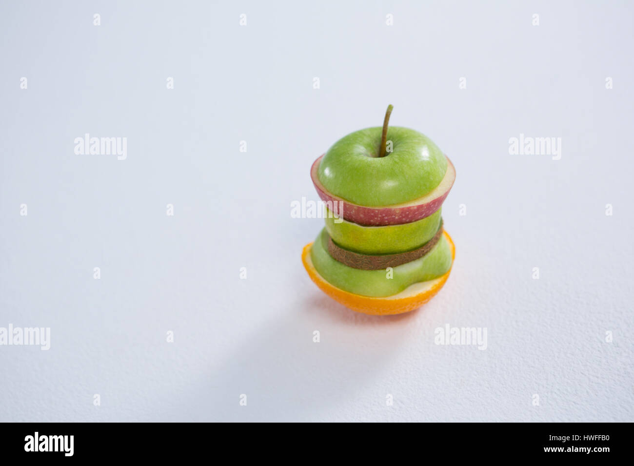 Stack of various fruits slices against white background Stock Photo - Alamy