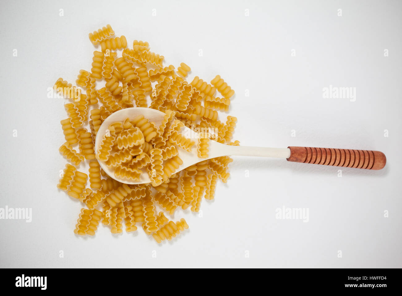 Gnocchi pasta spilling out of spoon on white background Stock Photo - Alamy