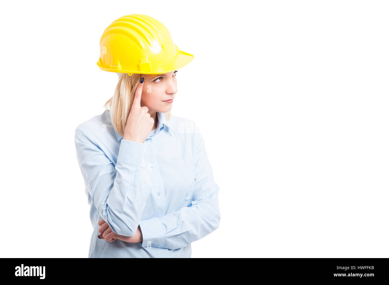Portrait woman engineer making thinking gesture looking up isolated on ...