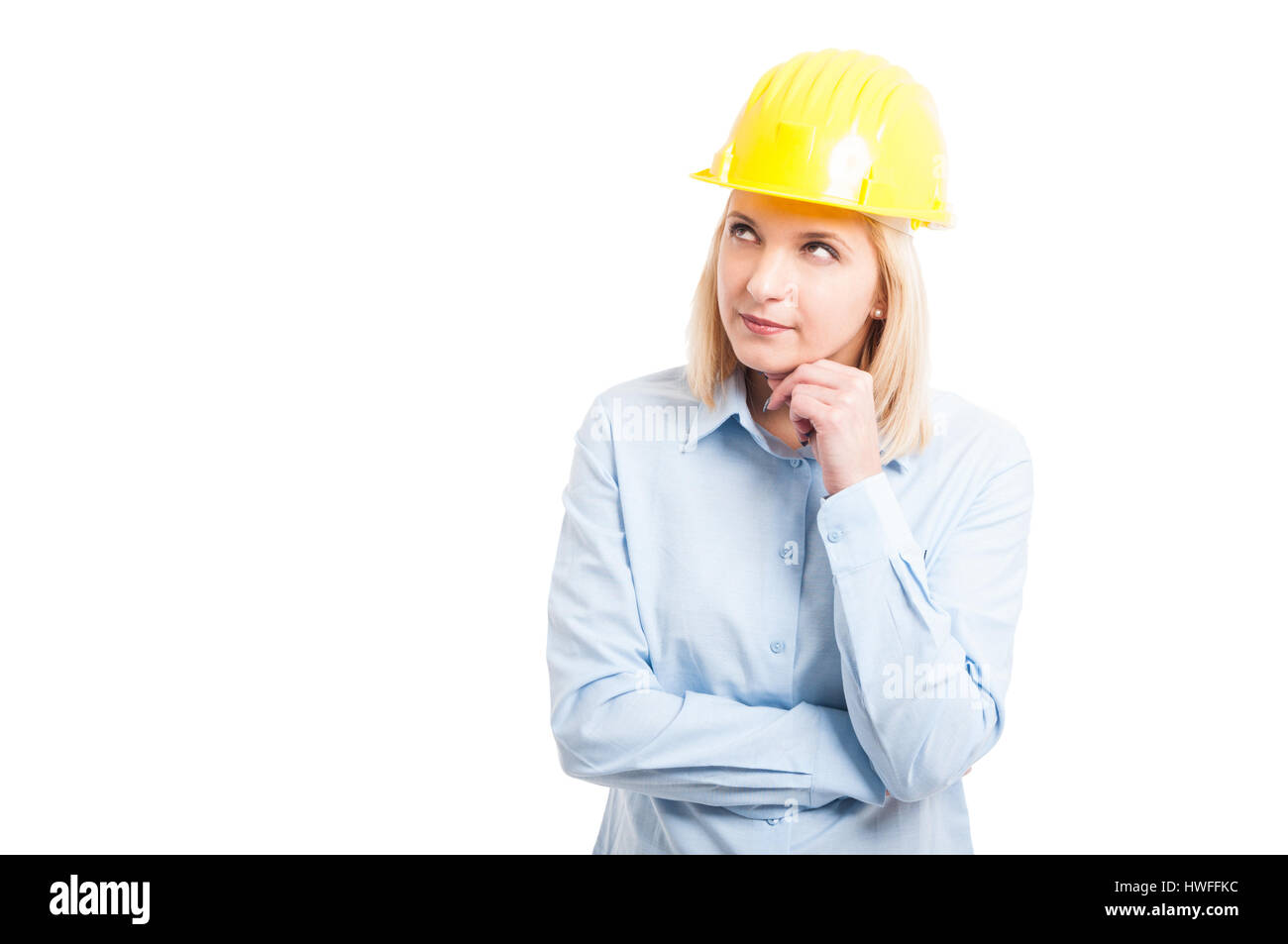 Portrait female engineer making thinking gesture looking up isolated on ...