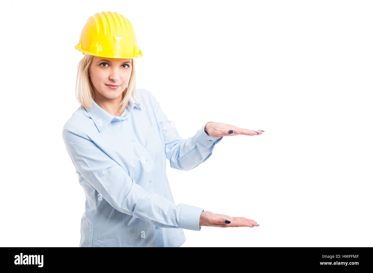 Lady engineer wearing helmet showing or holding copy space isolated on ...