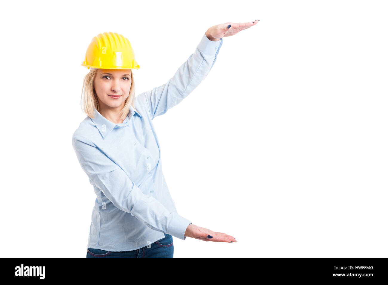 Lady engineer wearing helmet showing or holding big copy space isolated ...