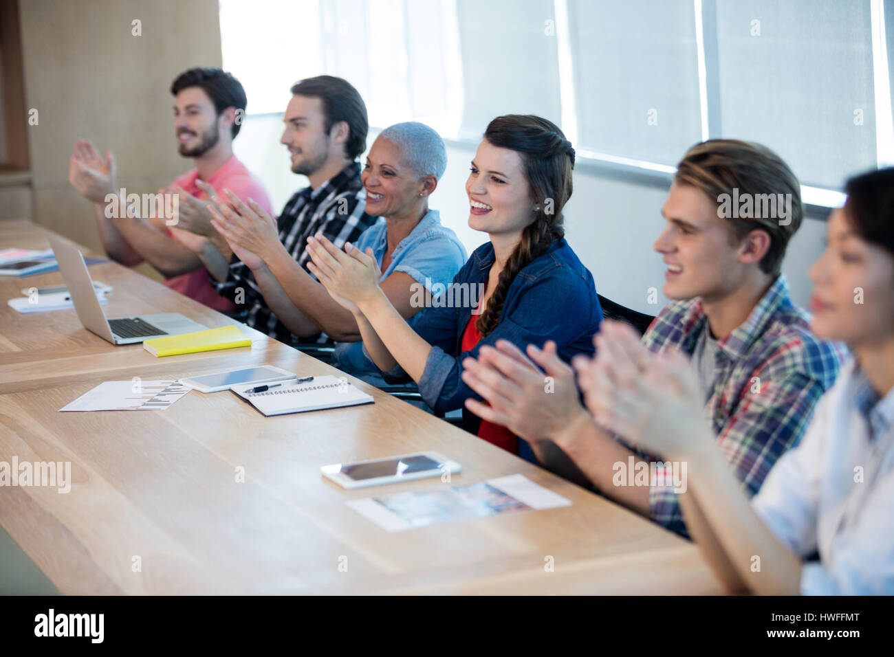 Creative business team applauding in meeting room at office Stock Photo ...