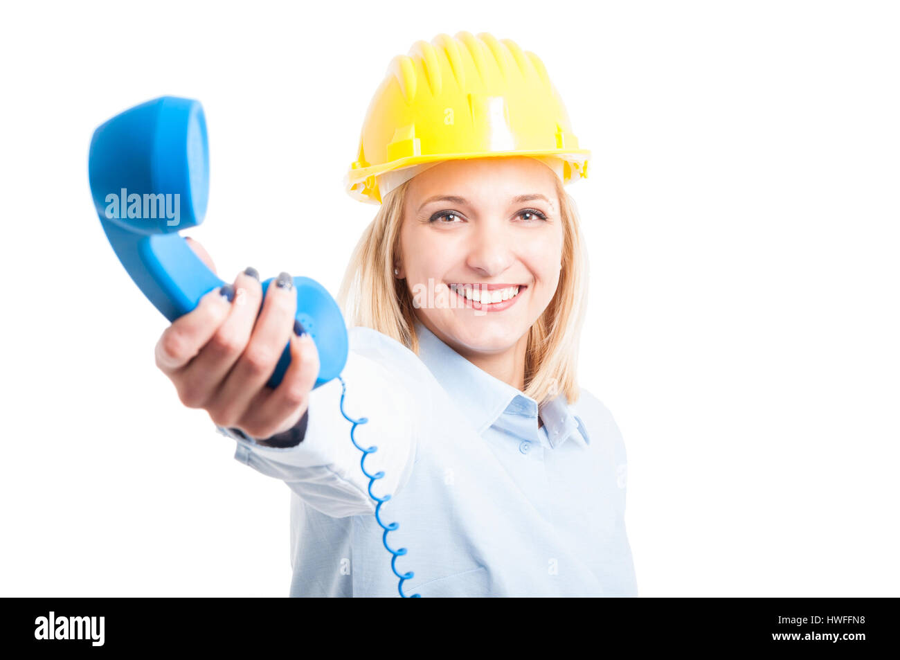 Woman architect wearing helmet showing telephone receiver and smiling ... Woman architect wearing helmet showing telephone receiver and smiling ...