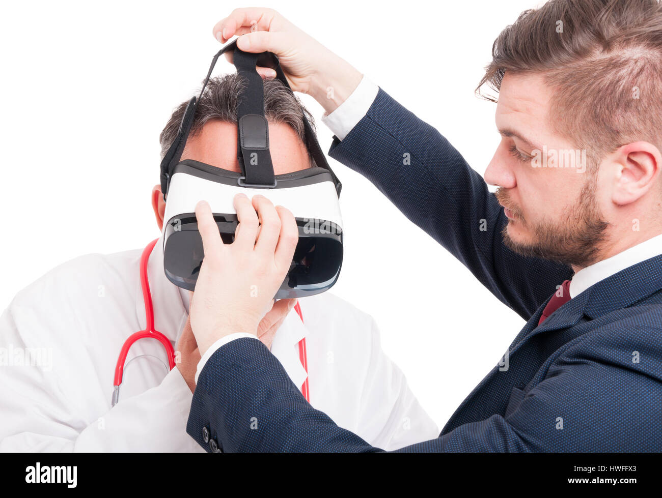 Young entrepreneur putting futuristic device on medic head to ...