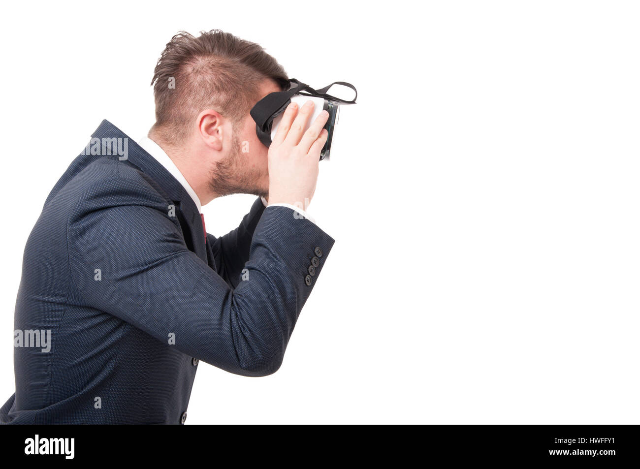 Young man wearing vr virtual reality headset on white studio background ...