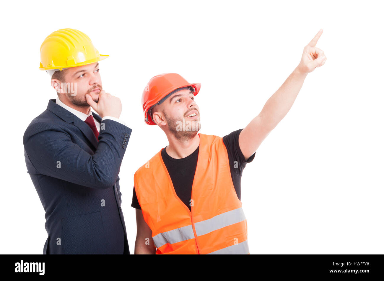 Handsome constructor pointing finger up and showing something to ...