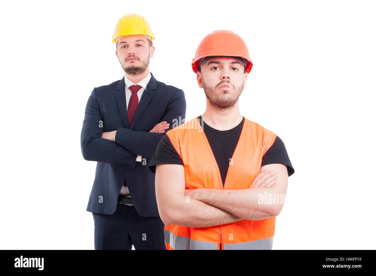 Serious builder and architect behind him standing with arms crossed on ...