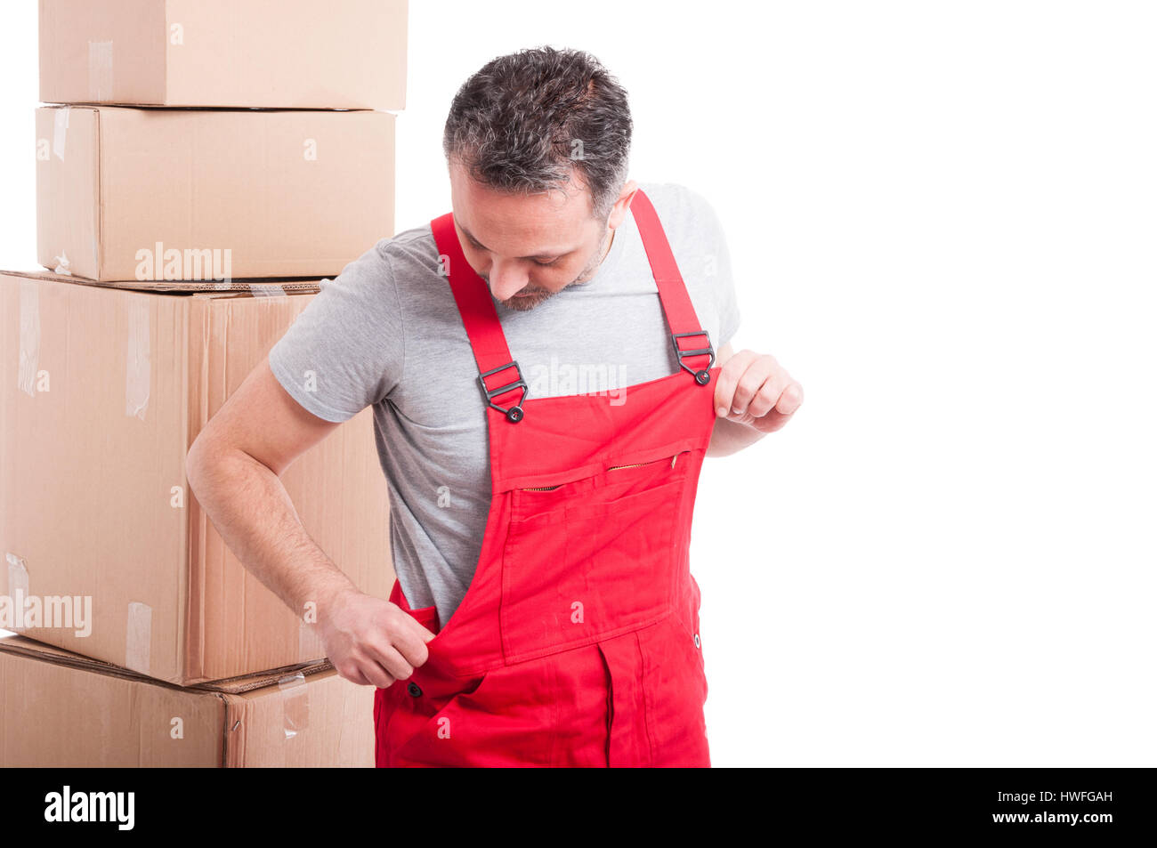 Mover guy surrounded by cardboard boxes arranging his red overall ...