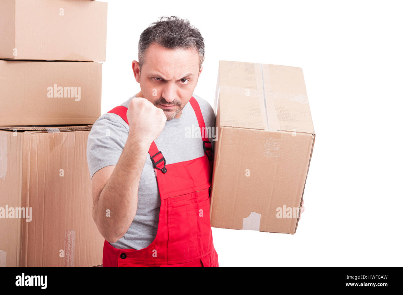 Mover guy holding cardboard box showing fist looking angry isolated on ...