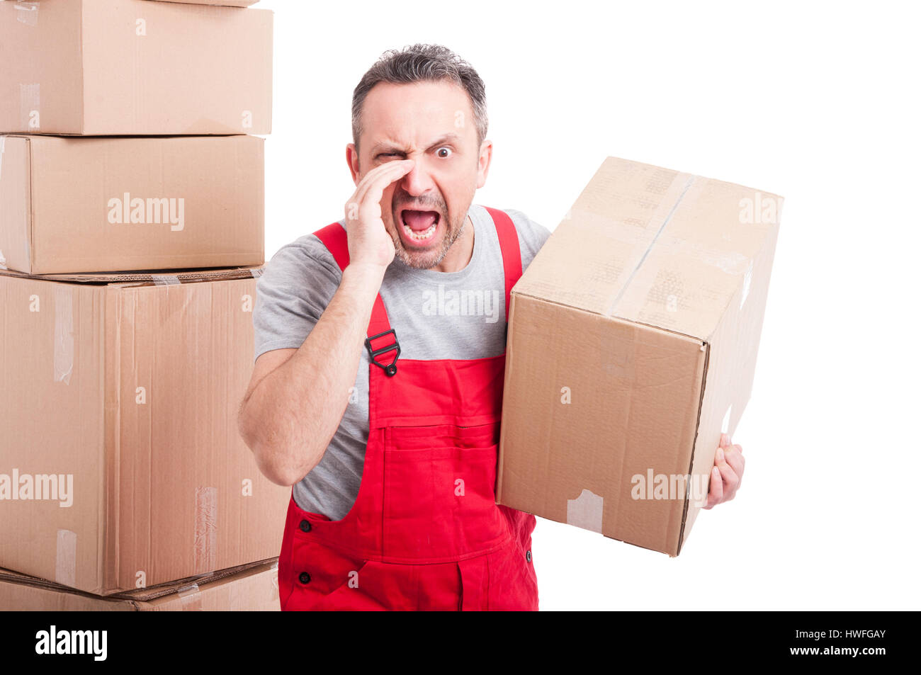 Portrait of mover man holding box and screaming loud looking very mad ...