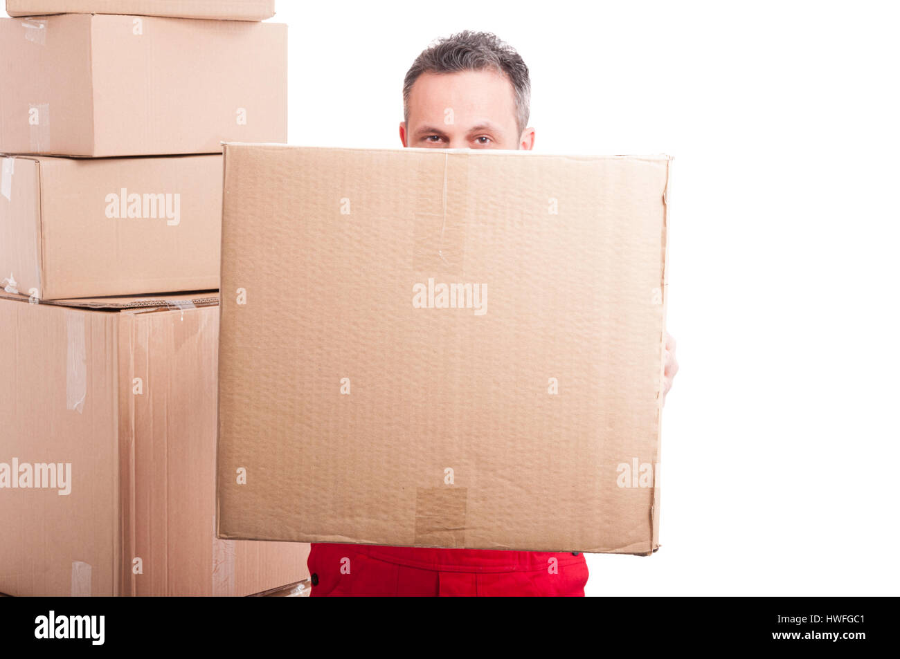 Mover guy hiding behind a big cardboard box isolated on white ...