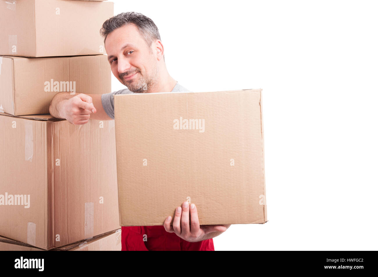 Mover guy wearing red overall holding and pointing a big cardboard box ...