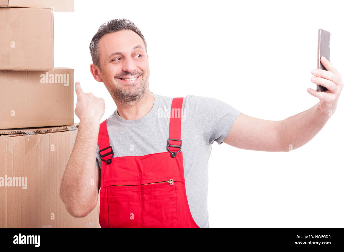 Mover guy pointing box and taking selfie and smiling isolated on white ...