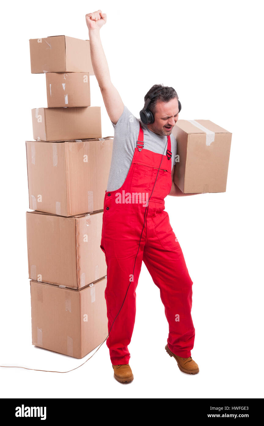 Full body of mover man dancing with headphones on with cardboard boxes ...