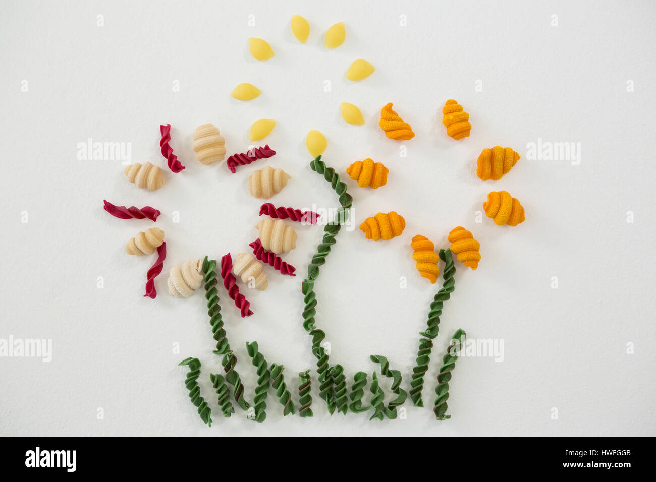 Varieties of pasta forming flower on white background Stock Photo - Alamy