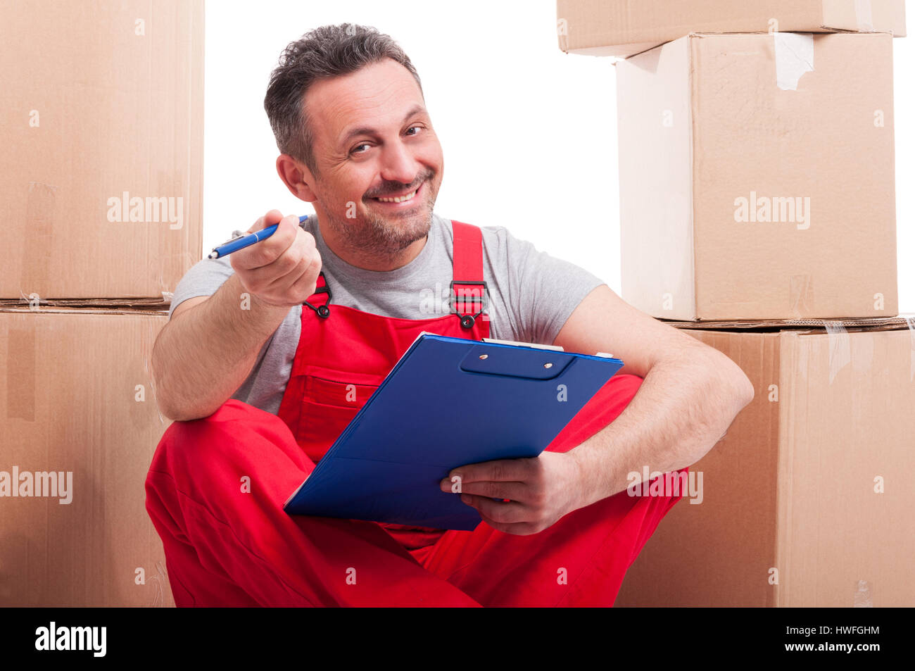 Mover guy sitting down on the floor holding clipboard offering pen to ...