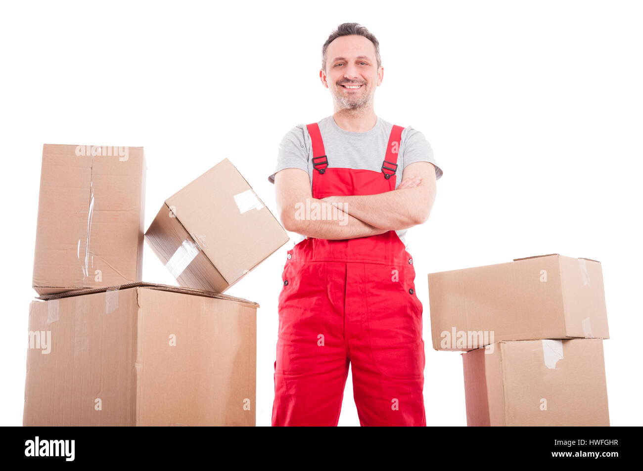 Mover man standing with arms crossed between cardboard boxes and ...