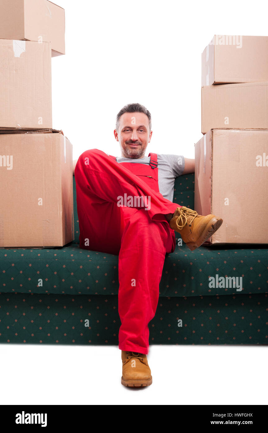Mover man sitting on couch with cardboard boxes around and smiling like ...