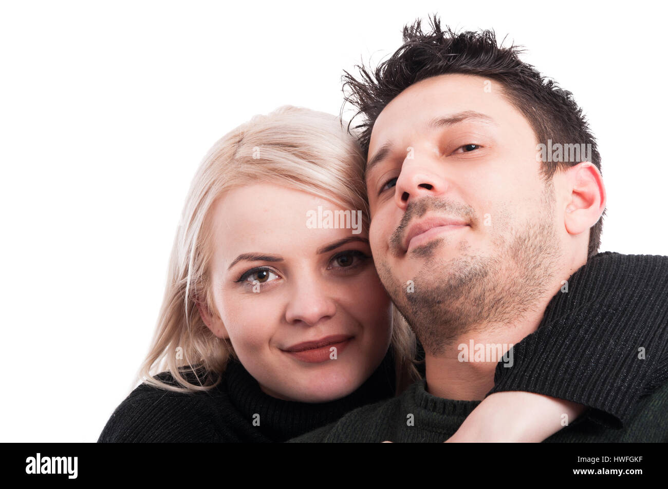 Closeup picture of young smiling lovers posing on white background ...