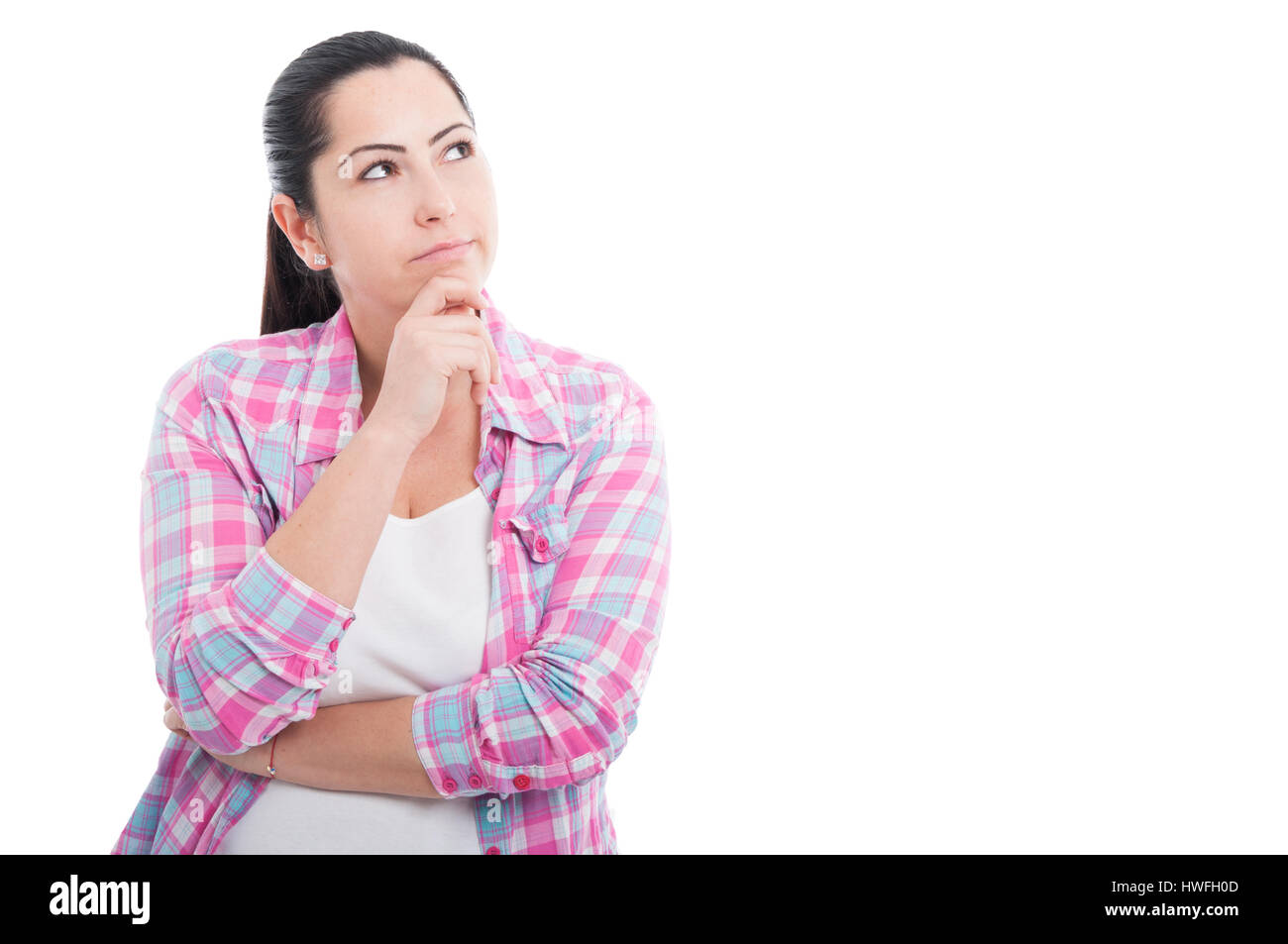 Pretty woman thinking at something with hand on chin on white ...