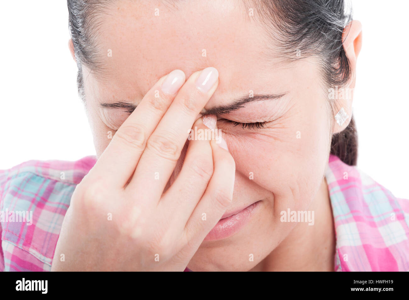 Closeup of woman suffering of headache and looking tired on white ...