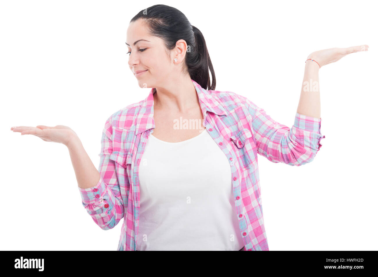 Gorgeous lady showing something invisible in her hands with advertising ...