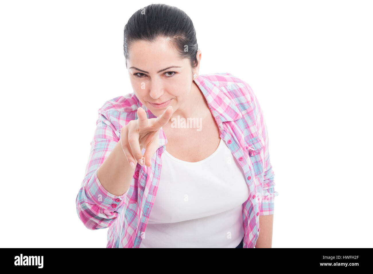 Young girl making watching you gesture with one hand as attention ...