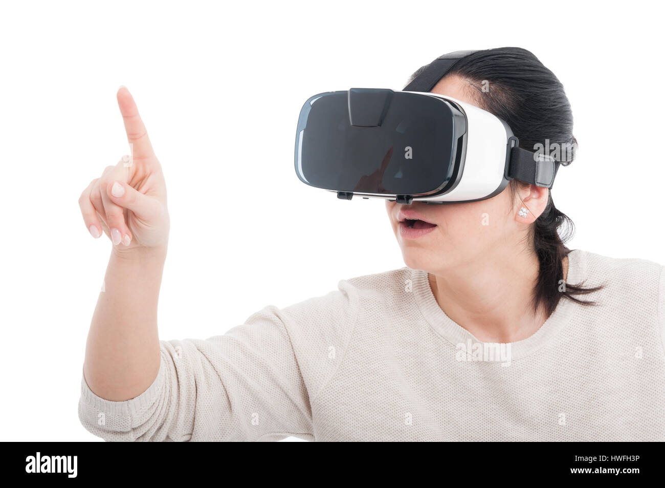 Female getting experience using VR headset and pointing on empty screen ...