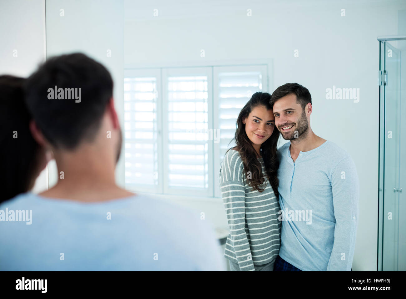 Romantic couple looking in bathroom mirror together Stock Photo - Alamy