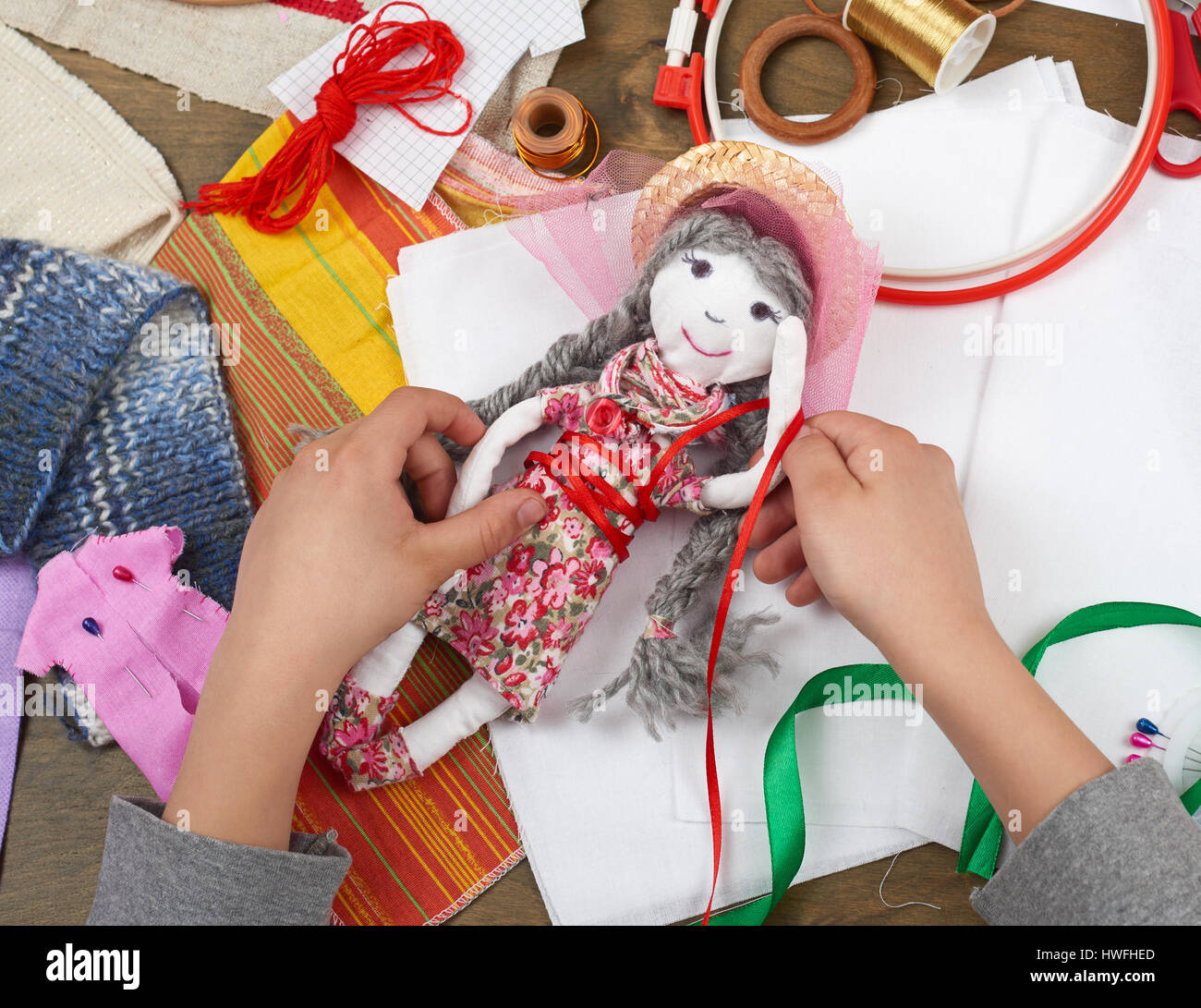 child hand making dress for handmade doll, learn to sewing Stock Photo ...