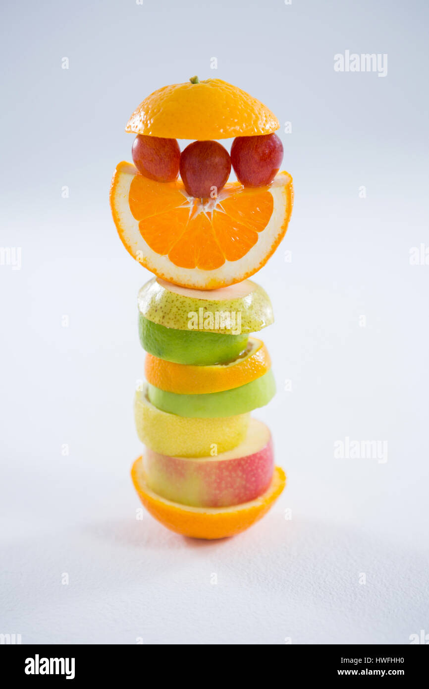 Stack of various fruits slices against white background Stock Photo - Alamy