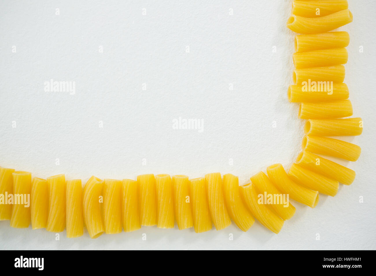 Sedani rigati pasta on arranged in a row on white background Stock ...
