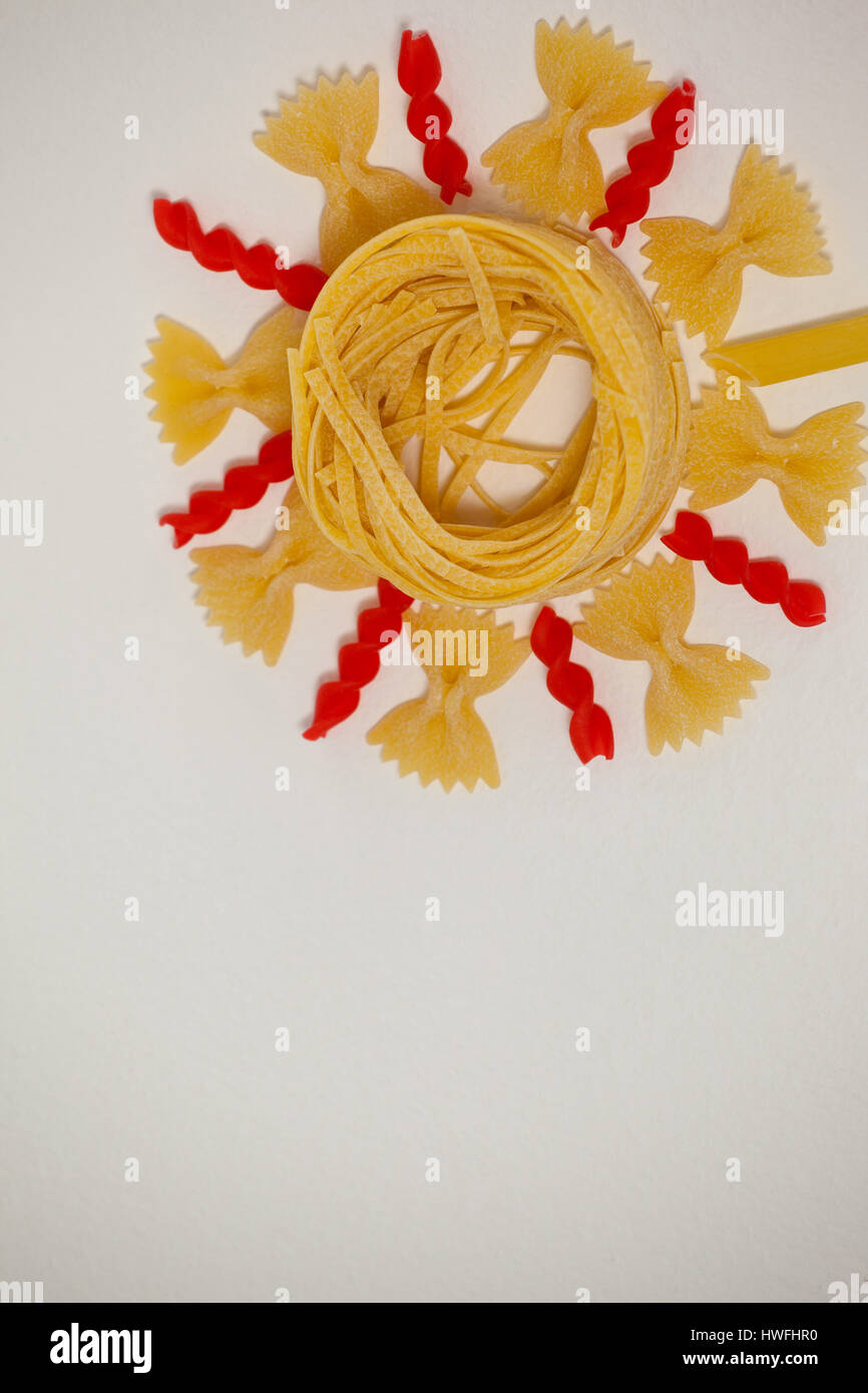 Varieties of pasta making a flower on white background Stock Photo - Alamy