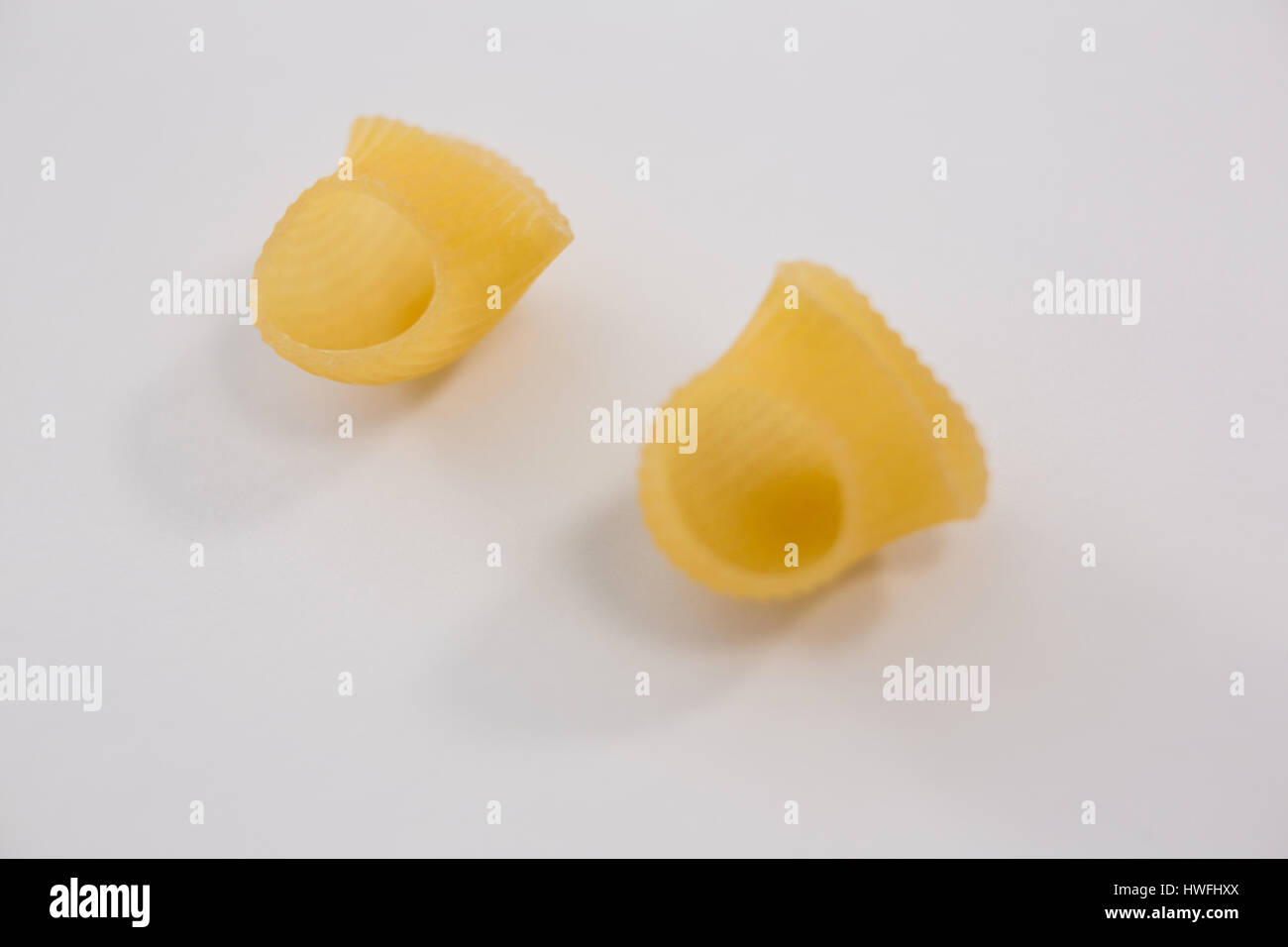 Two lumache rigate pasta on white background Stock Photo - Alamy