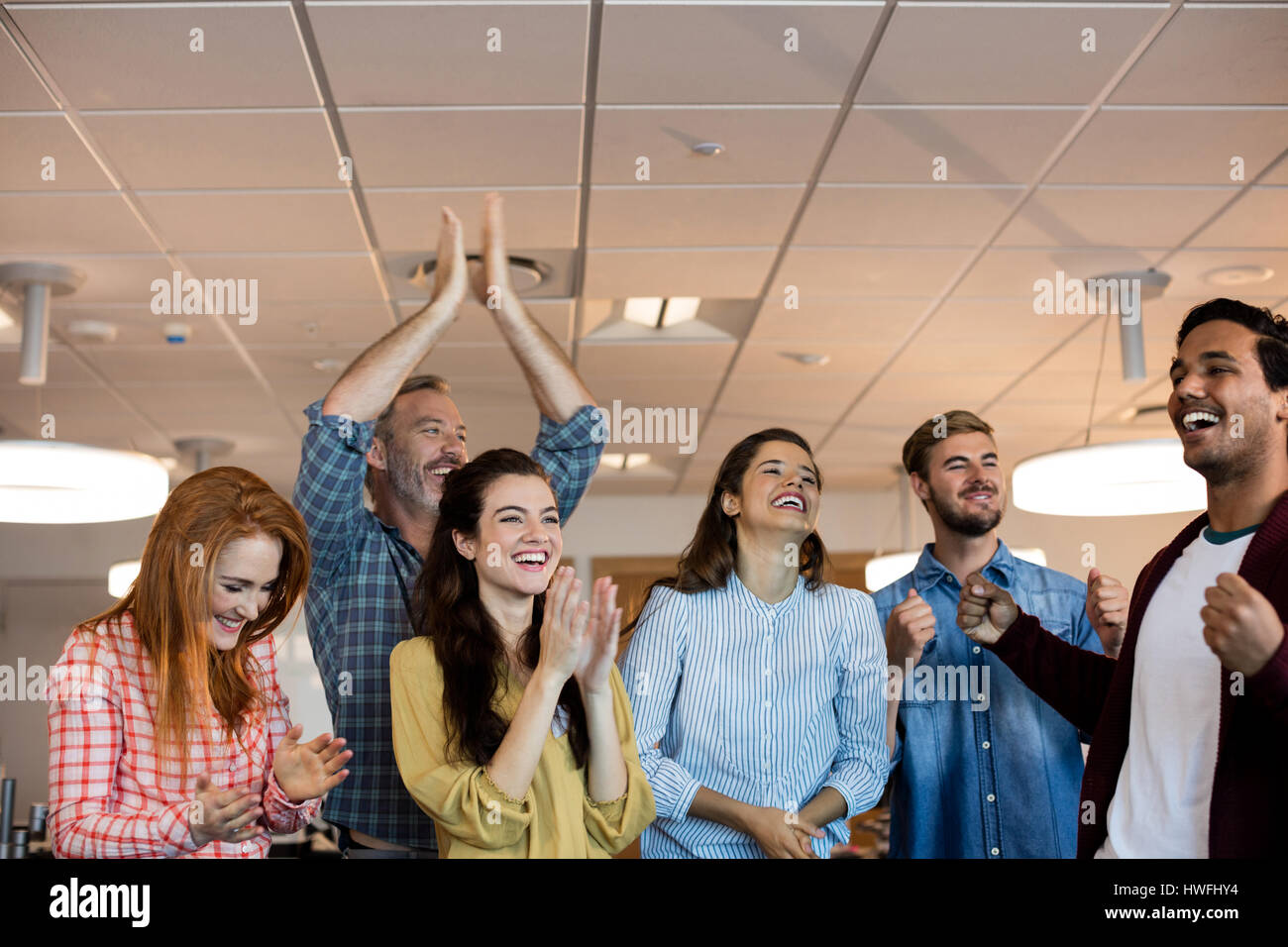 Happy creative business team celebrating success in office Stock Photo ...