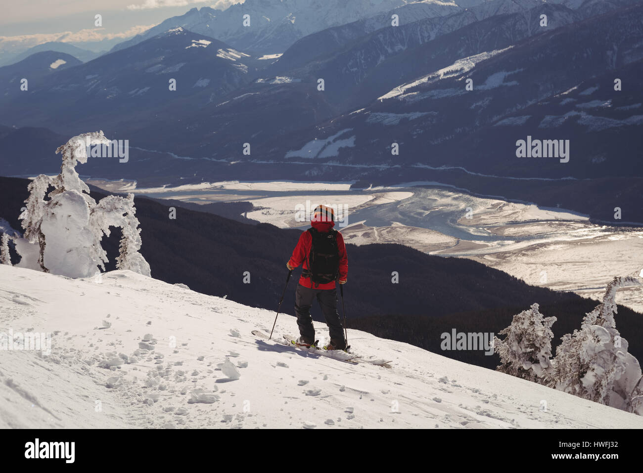 Rear view of skier skiing in snowy alps during winter Stock Photo - Alamy