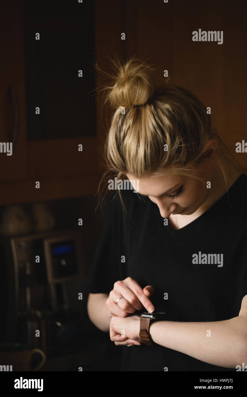 Woman checking watch home hi-res stock photography and images - Alamy