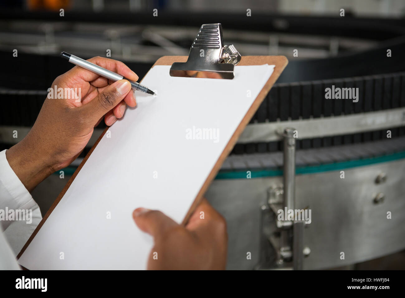 Factory worker holding paper clipboard hi-res stock photography and ...