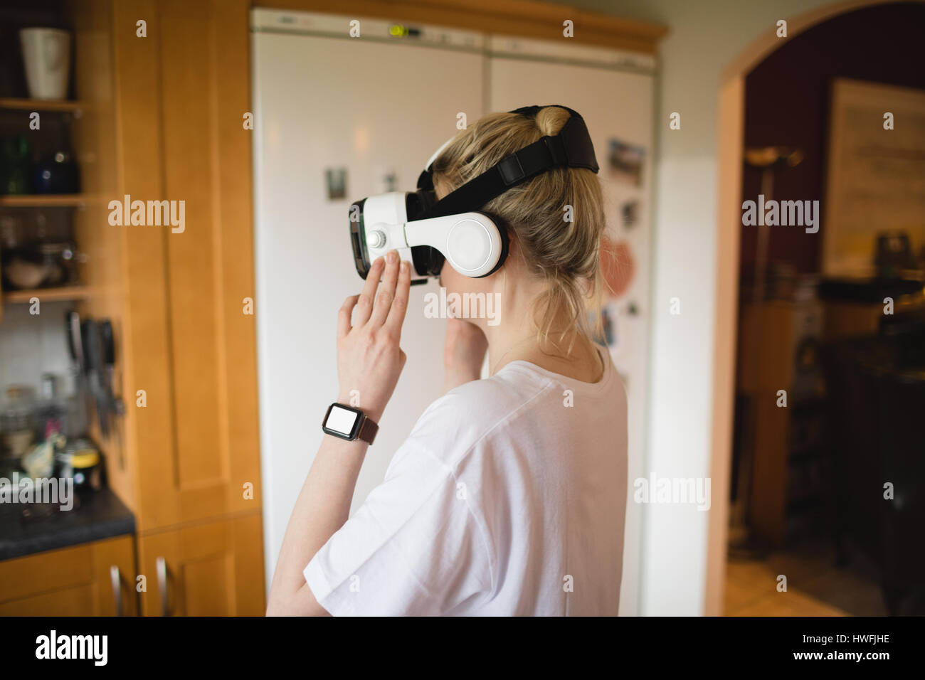 Woman using virtual reality headset at home Stock Photo - Alamy