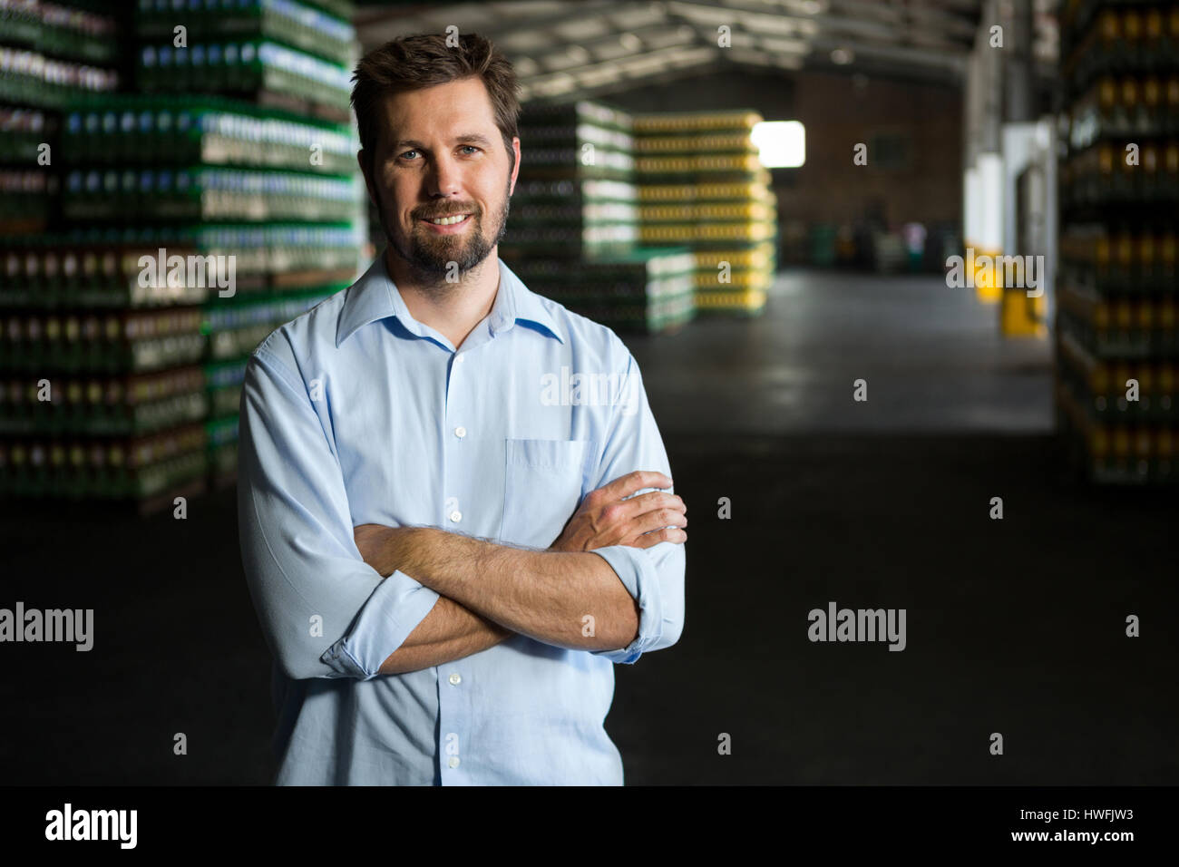 Portrait of confident male worker standing in warehouse Stock Photo - Alamy