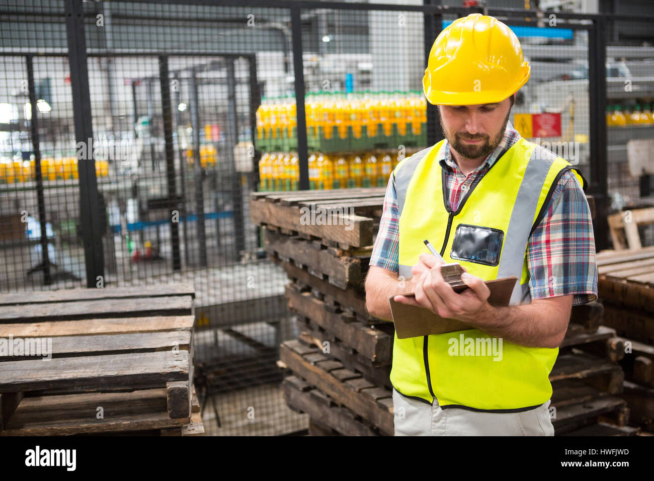 Confident male worker noting about products in warehouse Stock Photo ...