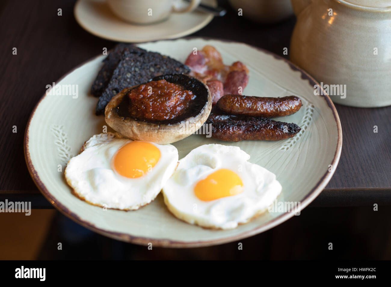 Plate of english breakfast with eggs and sausages on table Stock Photo ...